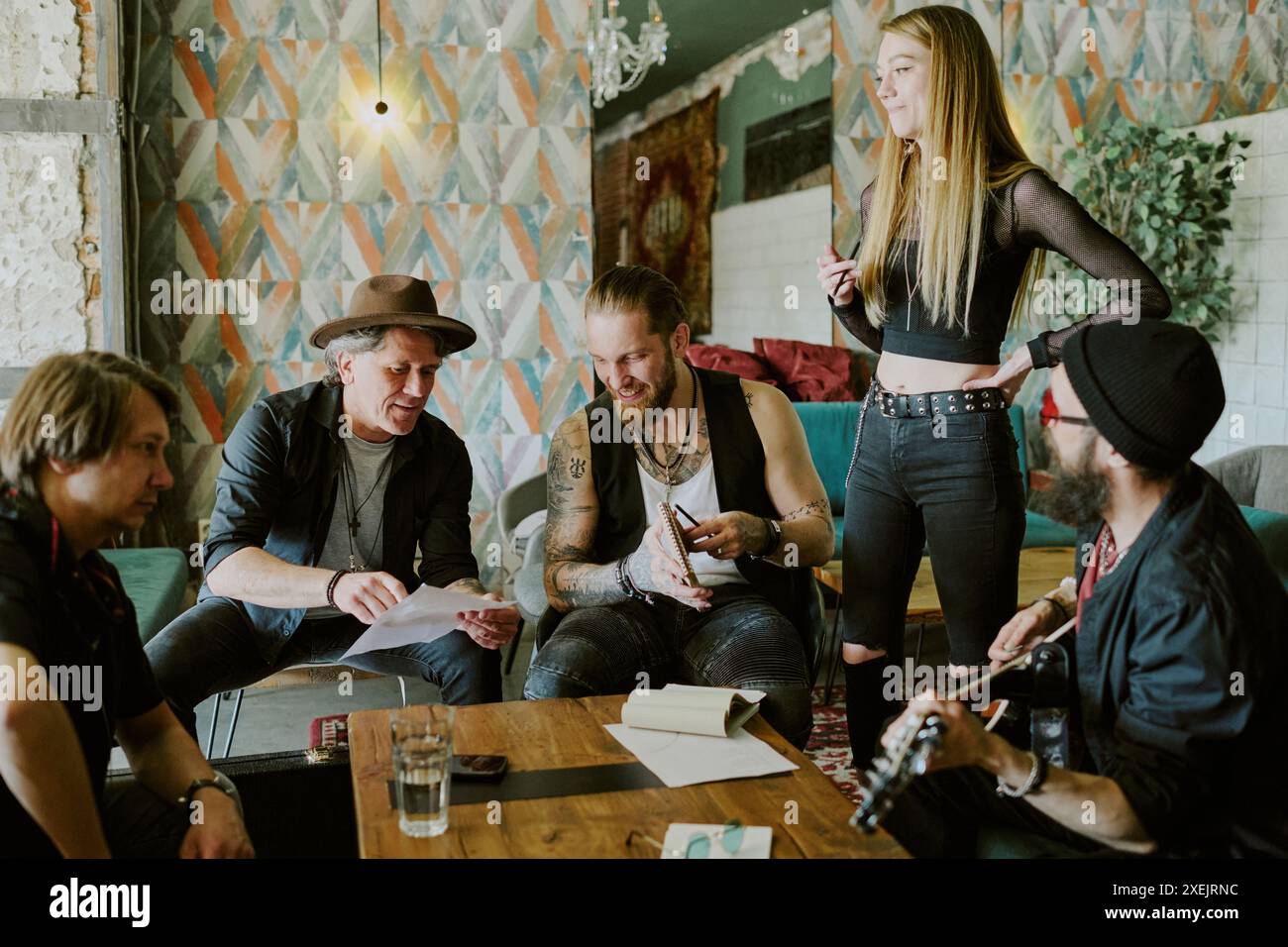 Group of gen X and gen Y musicians spending time in abandoned house ...