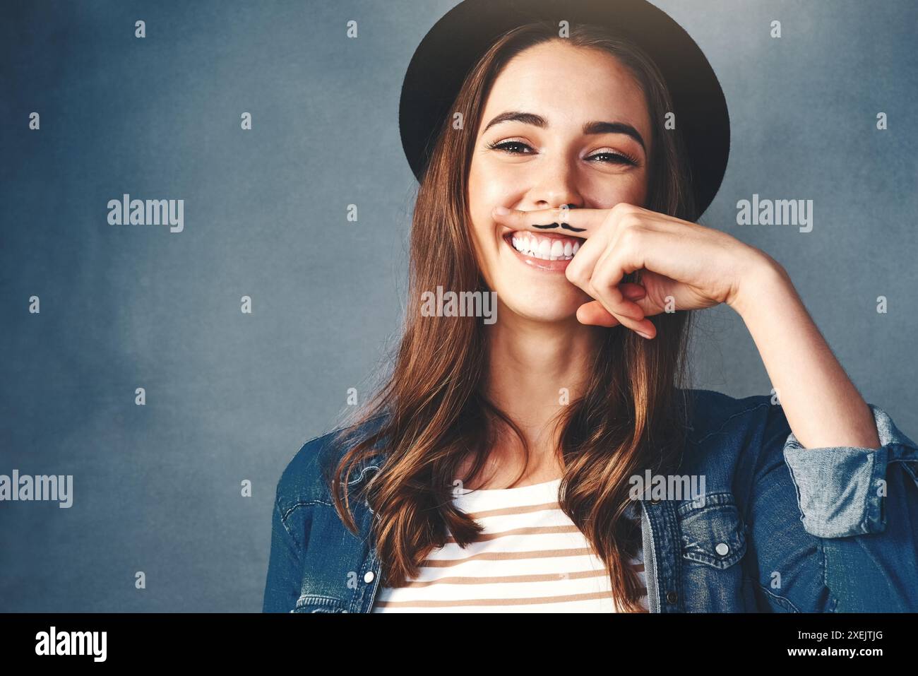 Girl, finger and mustache on studio background with portrait for quirky ...