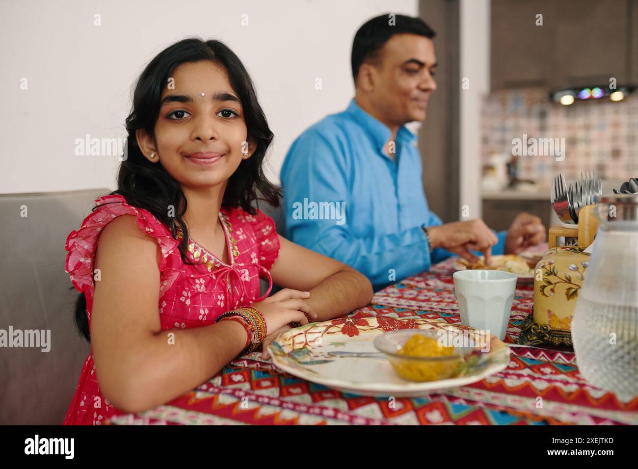 Indian Girl Sitting At Dining Table Stock Photo - Alamy