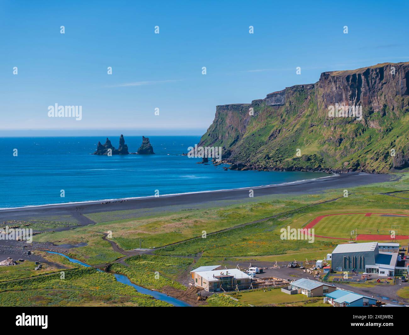 Aerial View of Black Sand Beach with Sea Stacks and Green Cliffs in ...