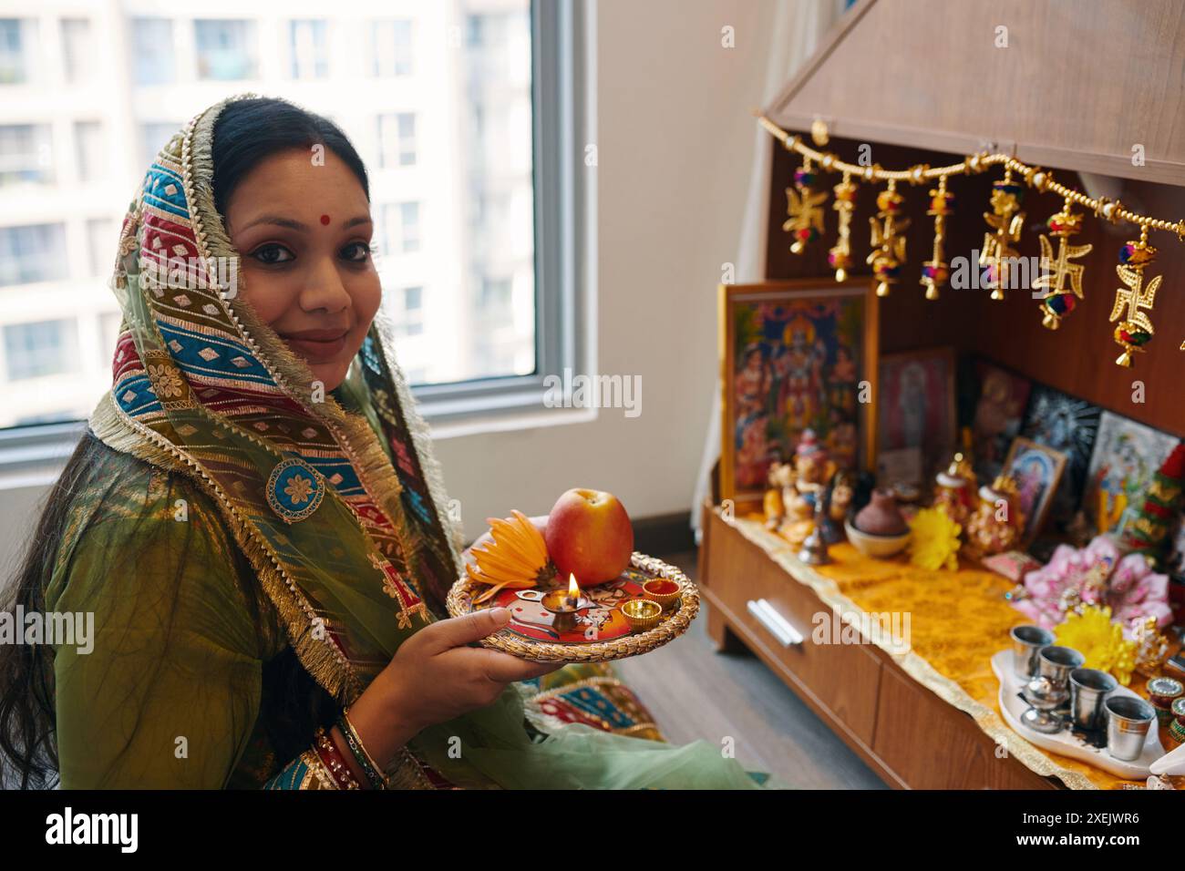 Indian Woman Making Offerings Near The Altar Stock Photo - Alamy