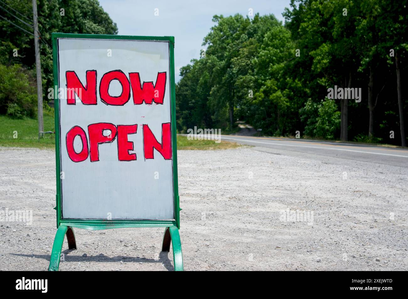 Now Open sign on the side of the highway with copy space to the right ...