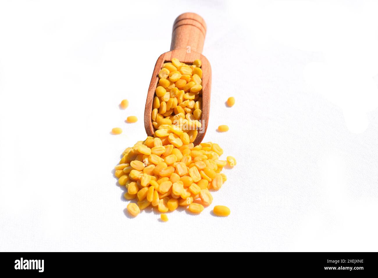 Toor dal or split yellow lentils in a wooden spoon isolated. Split ...