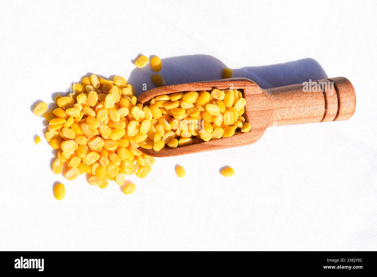 Toor dal or split yellow lentils in a wooden spoon isolated. Split ...