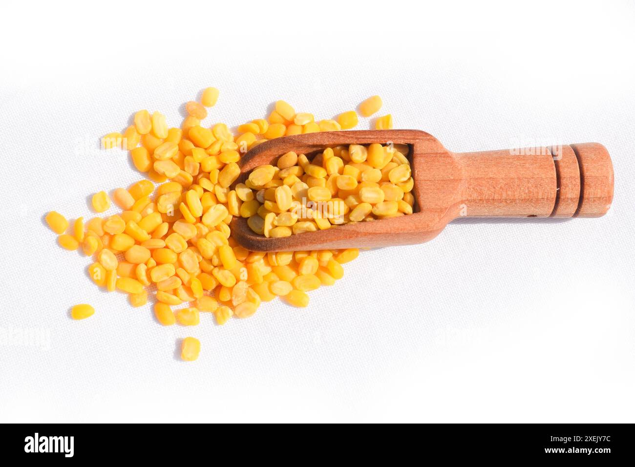 Toor dal or split yellow lentils in a wooden spoon isolated. Split ...