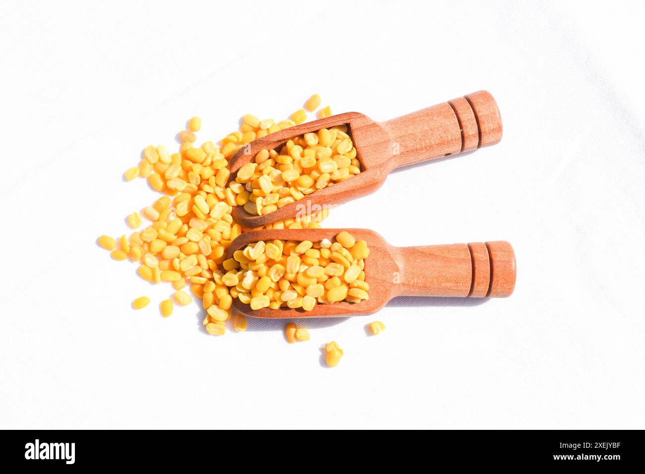 Toor dal or split yellow lentils in a wooden spoon isolated. Split ...