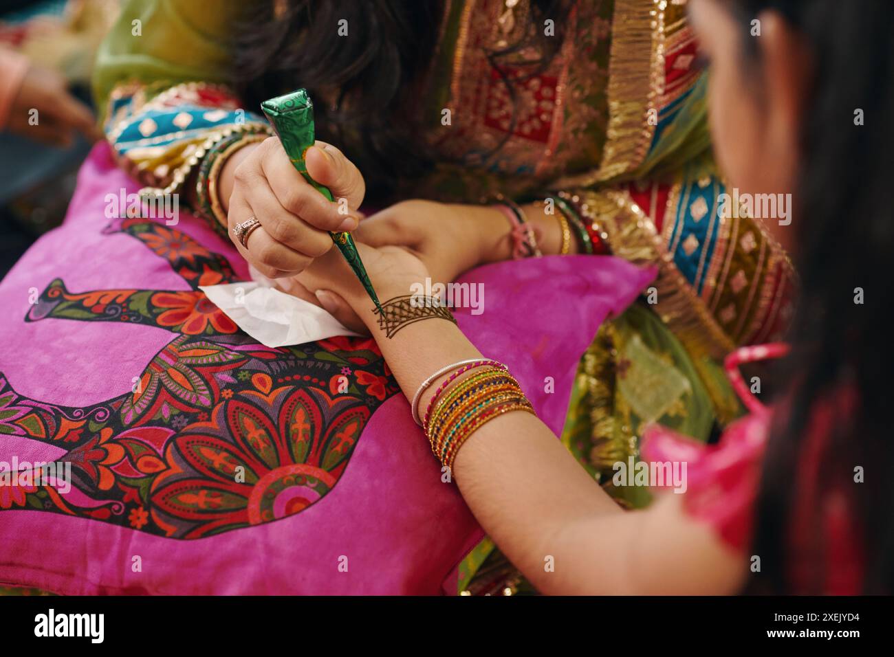 Mom Making Mehndi On Hand Of Her Daughter Stock Photo - Alamy