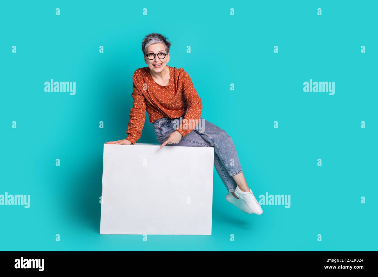 Full size photo of retired female sit point white cube empty space wear ...