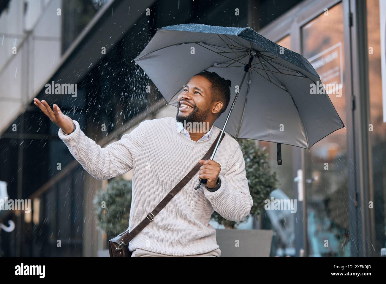 Rain, walking and black man in city with smile, happiness and travel to ...