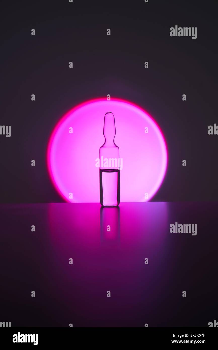 Several ampoules for injection with medicines on a lilac background ...