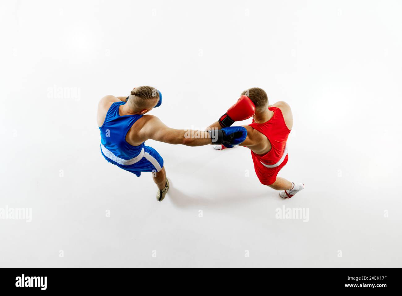 Overhead view of two boxers in action, one in red gear throwing punch ...