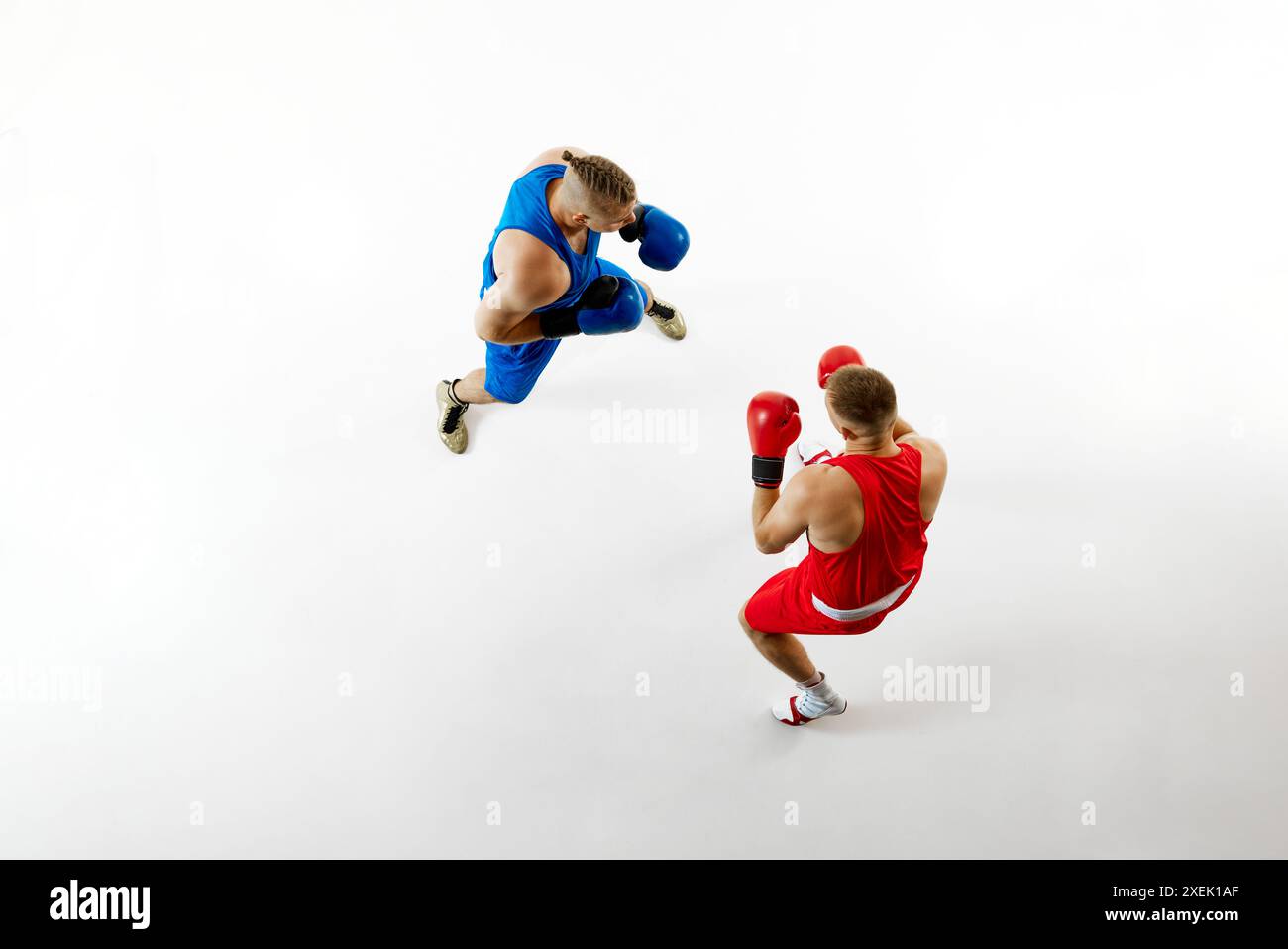 Overhead view of boxing match, boxer in red attire preparing to punch ...