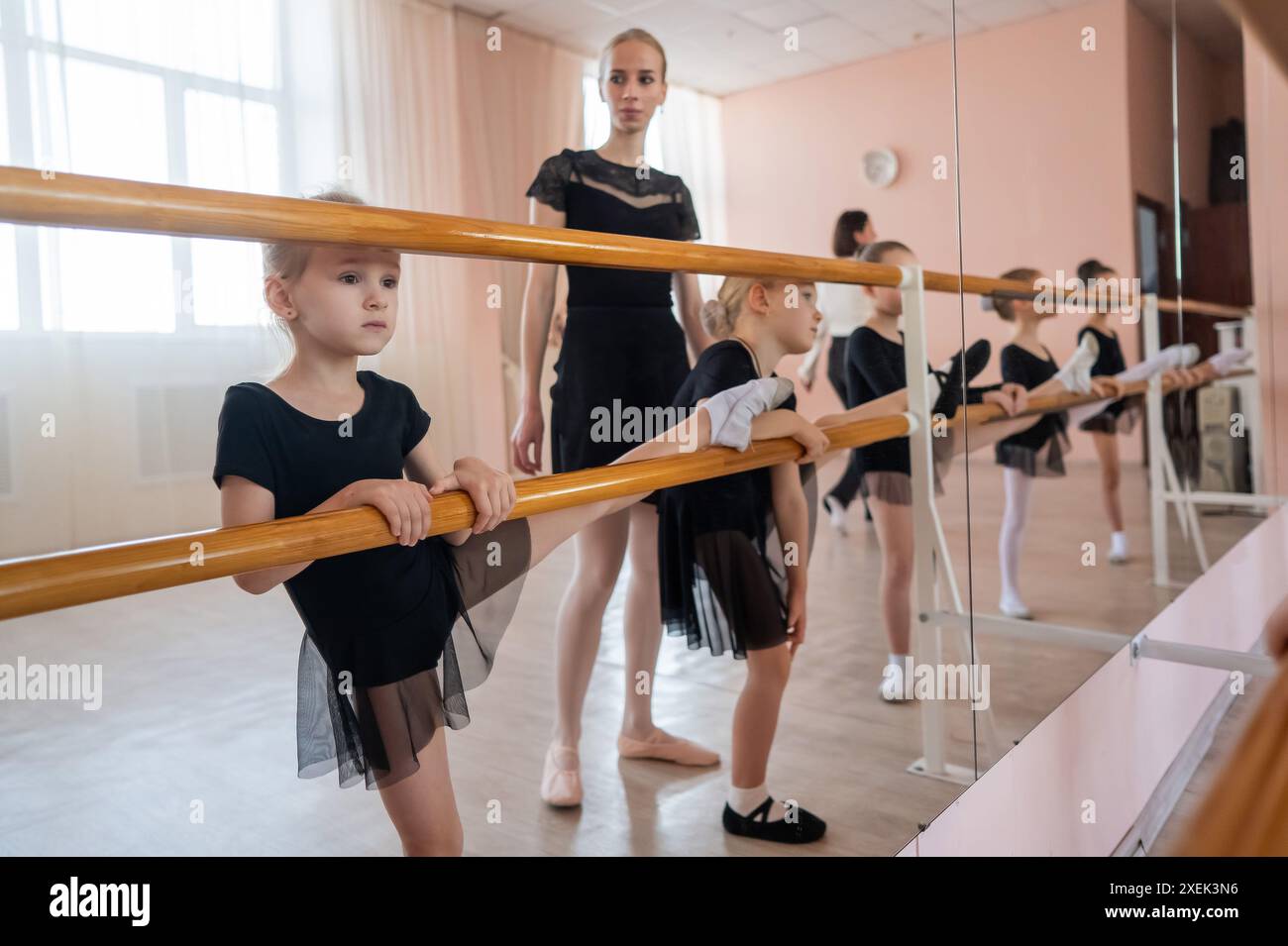 Little girls practice ballet at the barre Stock Photo - Alamy