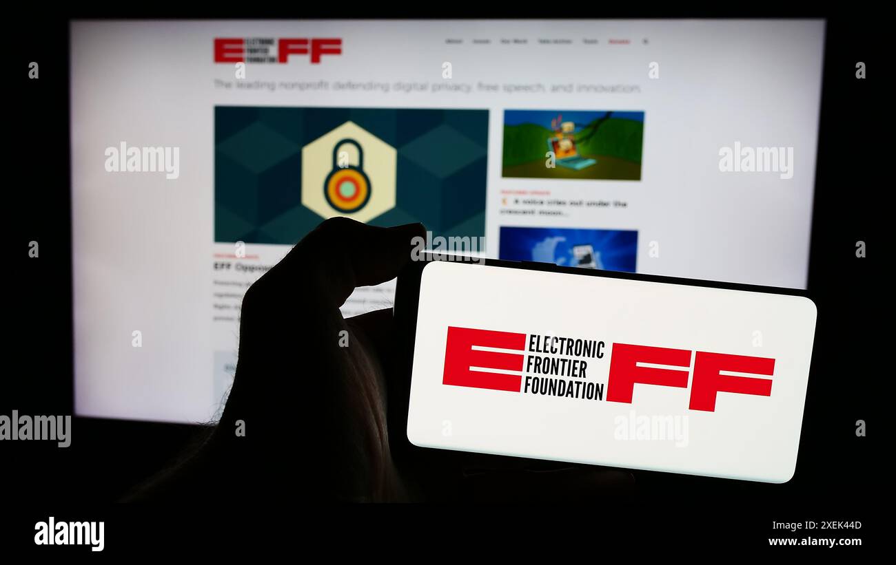 Person holding mobile phone with logo of organisation Electronic Frontier Foundation (EFF) in ...