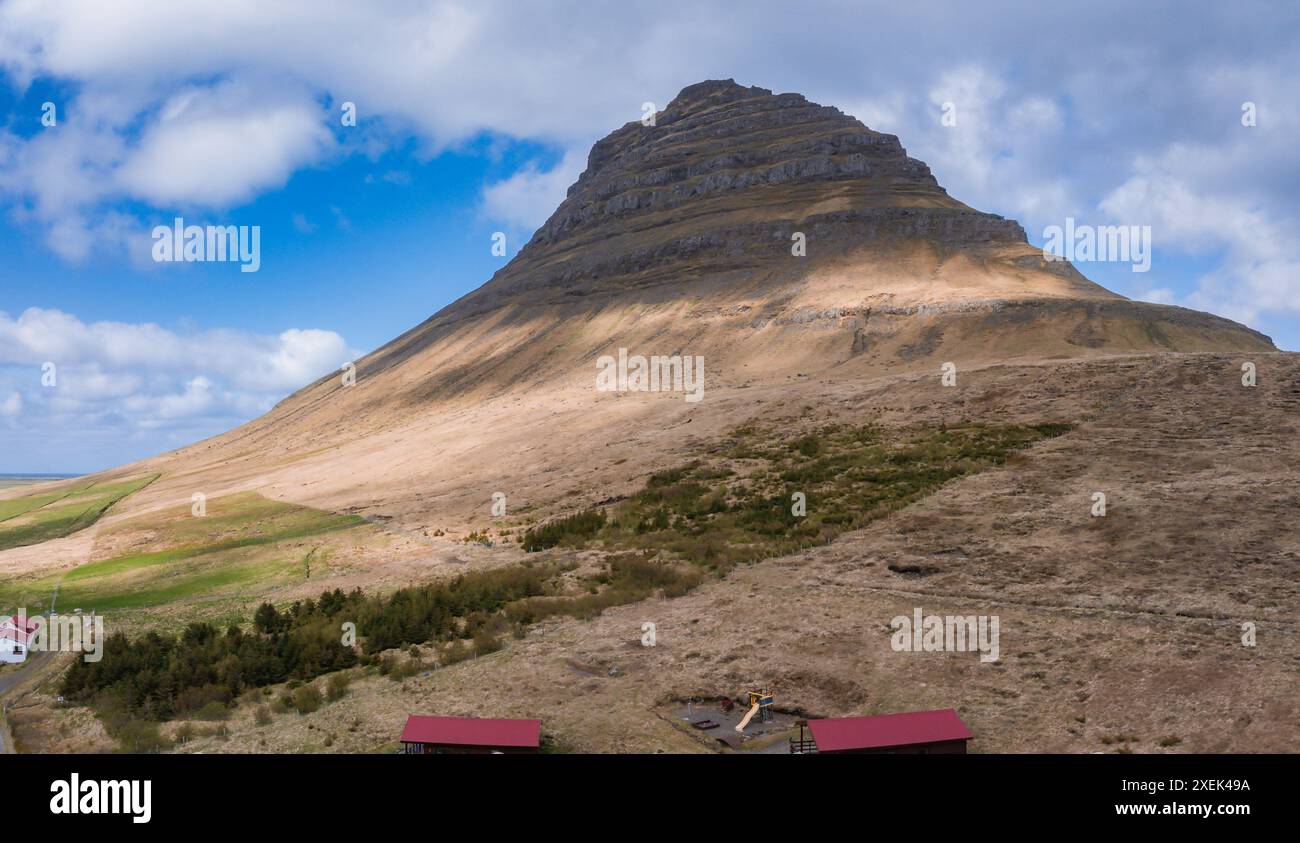 Aerial View of Kirkjufell Mountain with Grassy Field and Blue Sky in ...