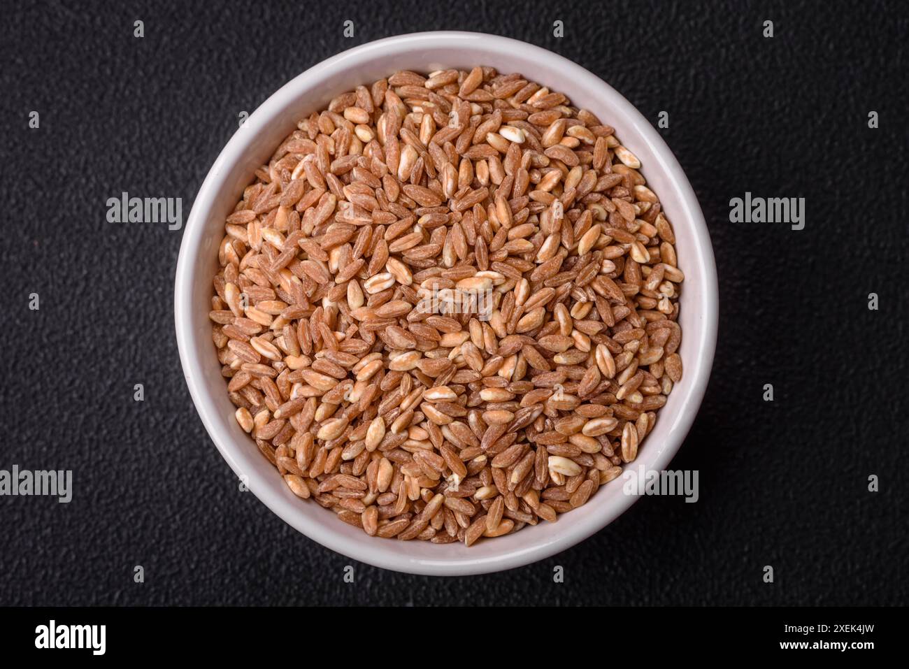 Large grains of wheat porridge are brown in color when raw Stock Photo ...