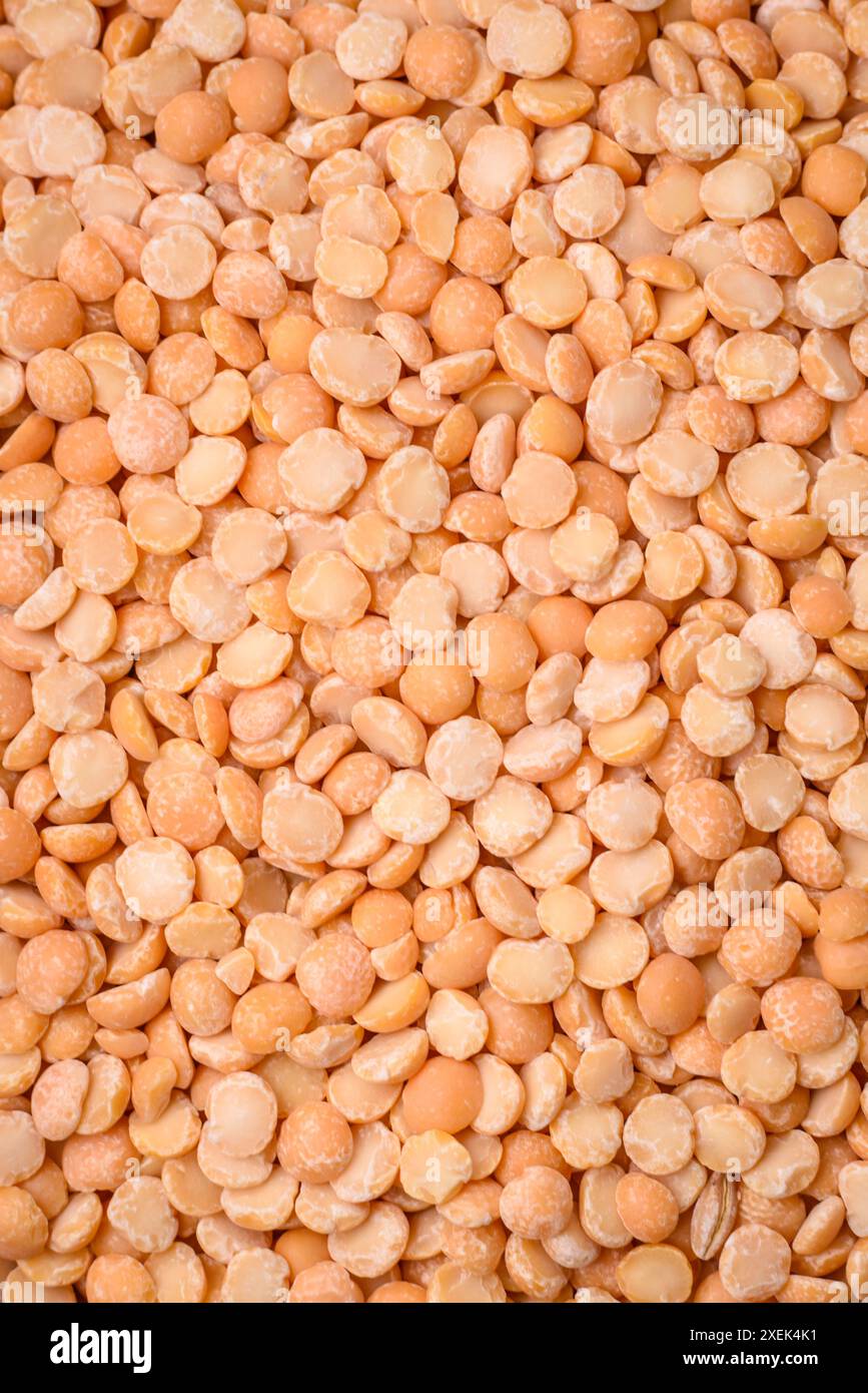 Dried pea grains, divided into halves, are yellow in color when raw ...