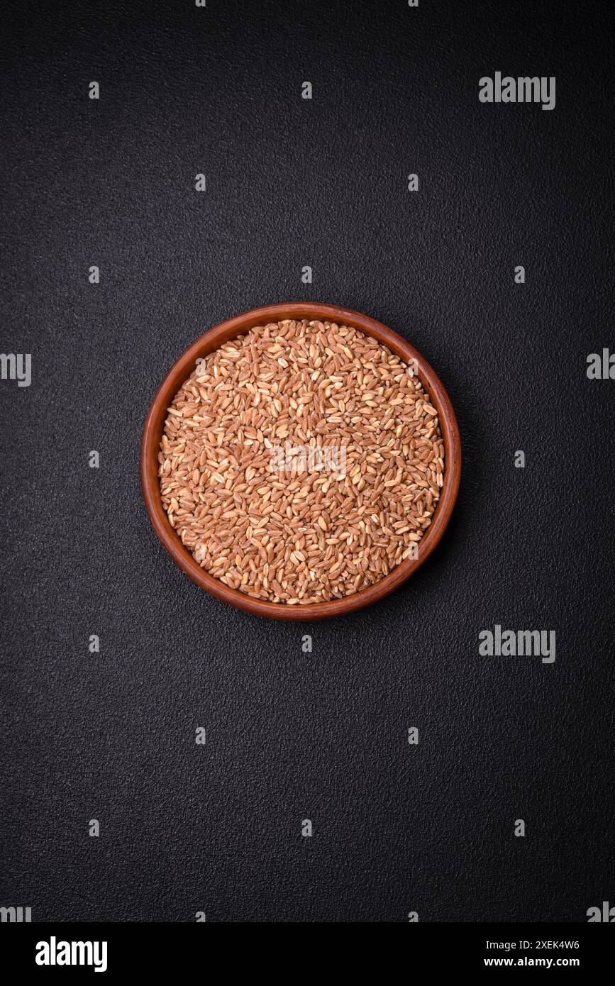 Large grains of wheat porridge are brown in color when raw Stock Photo ...