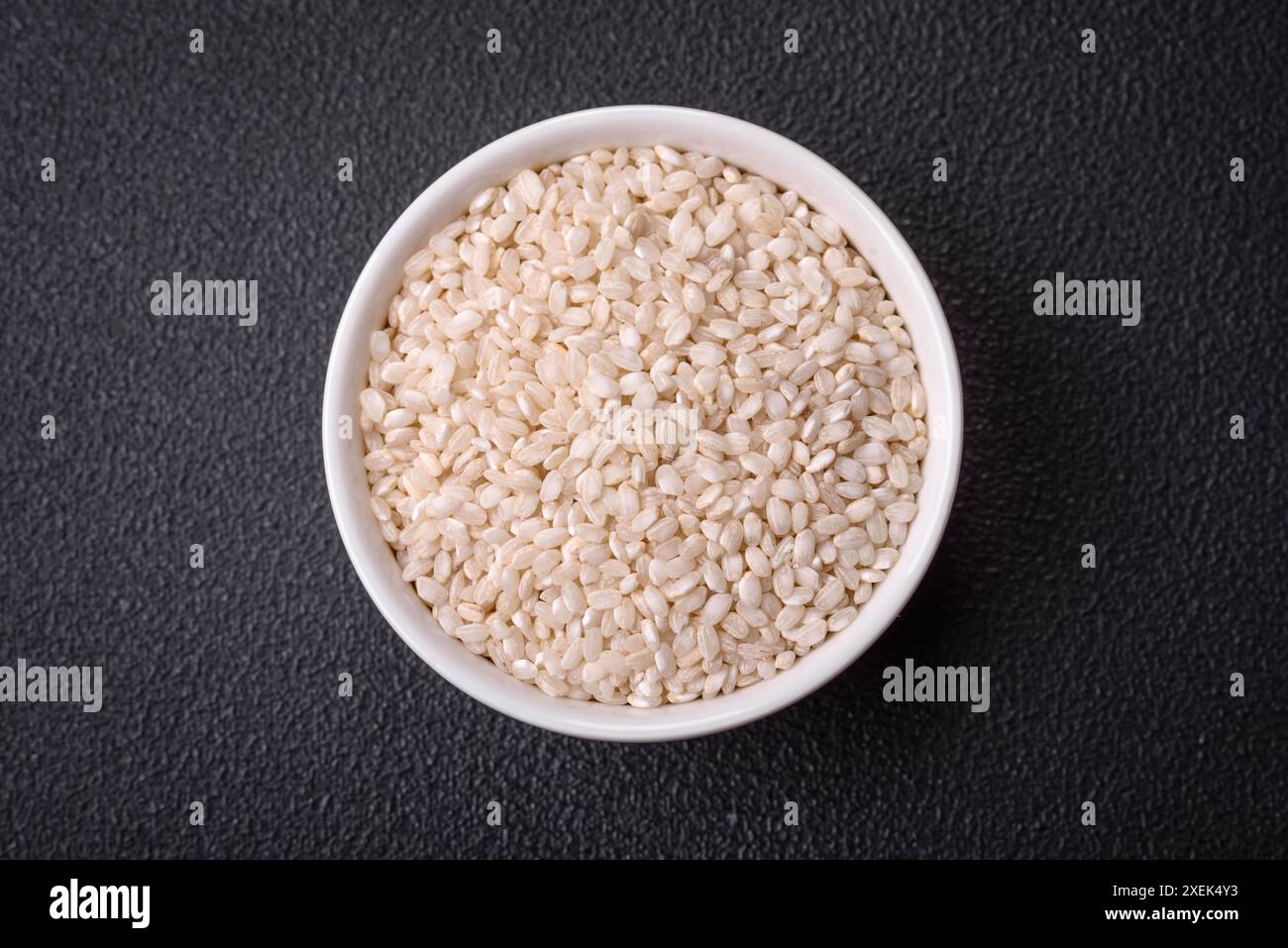 Large grains of uncooked white rice in a ceramic bowl Stock Photo - Alamy