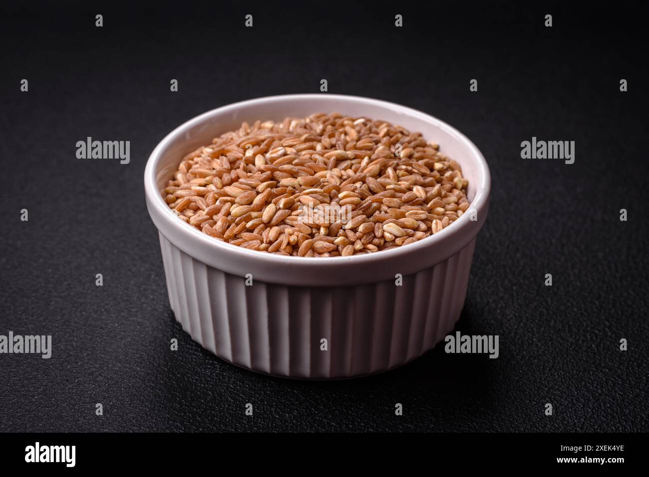 Large grains of wheat porridge are brown in color when raw Stock Photo ...