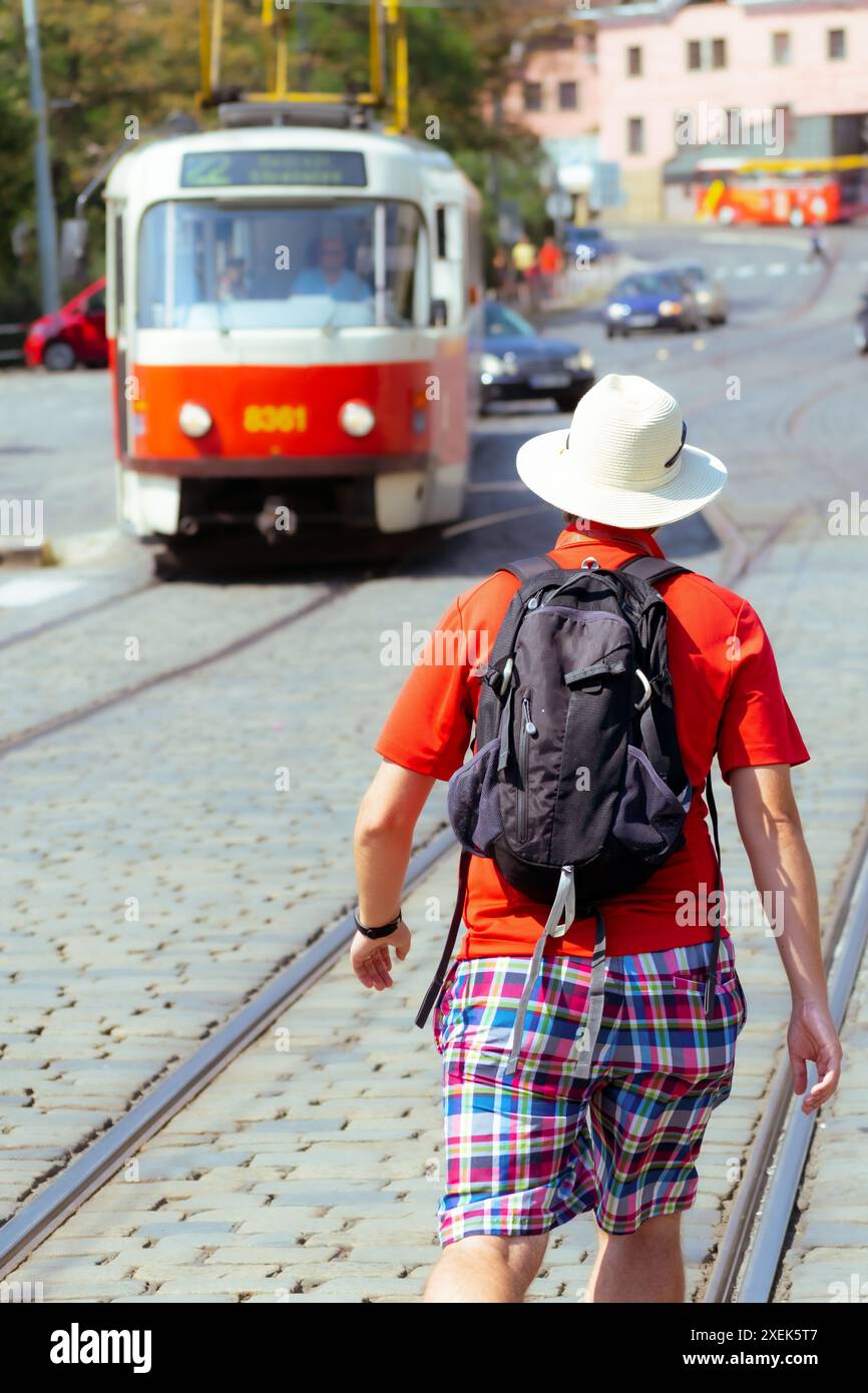 Guide or tourist wear red t-shirt and white summer hat back side view ...