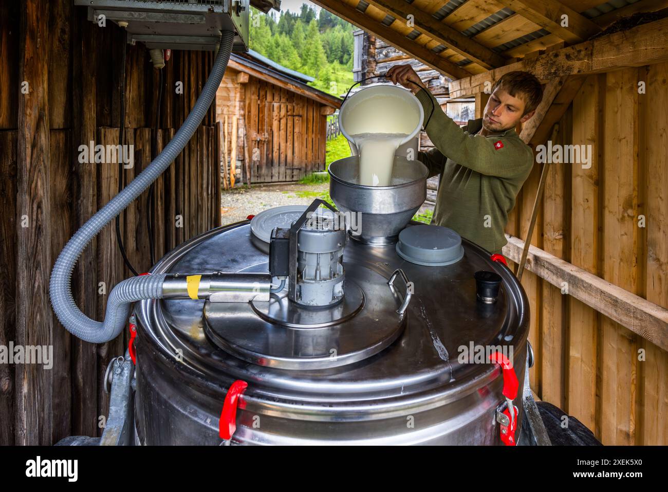 Farmer pours milk from bucket hi-res stock photography and images - Alamy