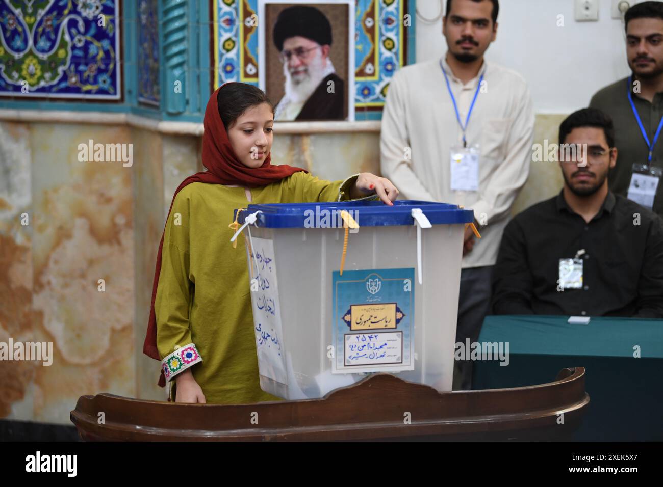 Tehran, Iran. 28th June, 2024. A voter casts her ballot for Iran's 14th ...
