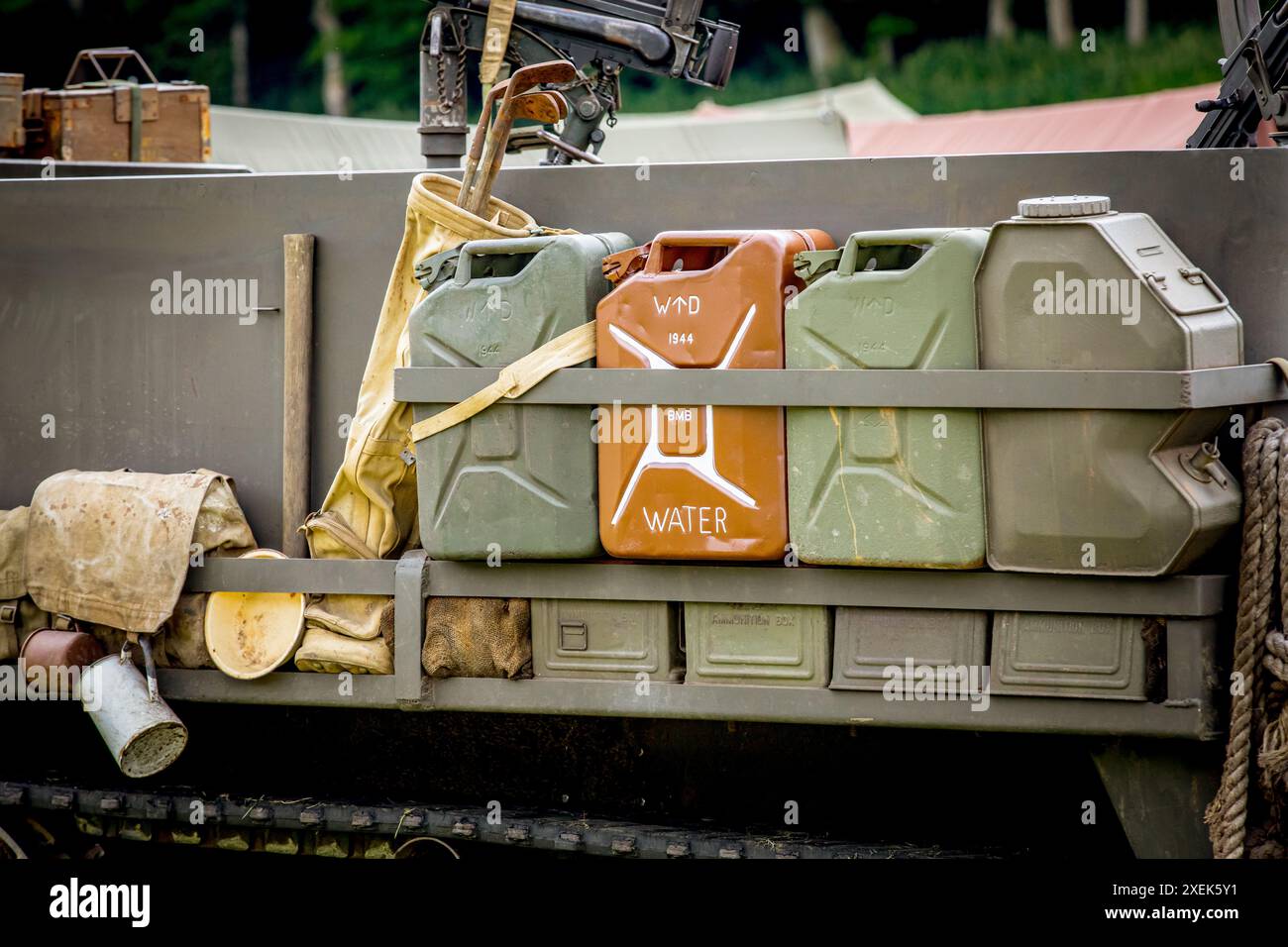 Old Jerry Cans and paraphinalia in a rack, on the side of World War 2 (WW2) tracked army vehicle ...
