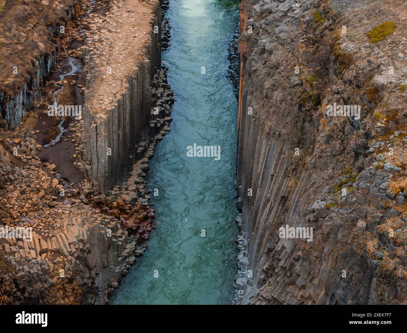 Aerial View of Vibrant Blue-Green River Flowing Through Jagged Canyon ...