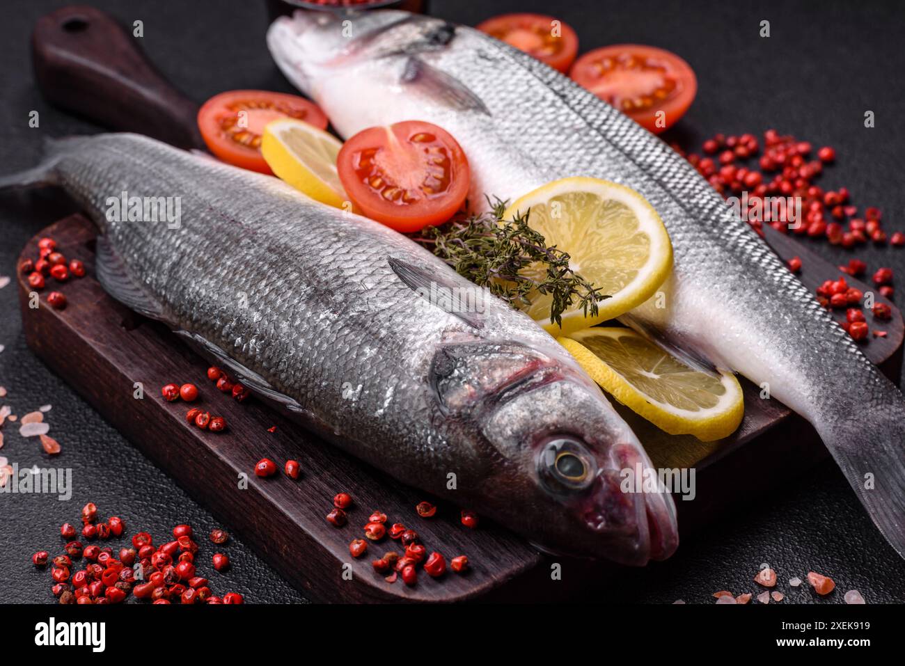 Fresh raw ocean sea bass fish with salt, spices and herbs Stock Photo ...