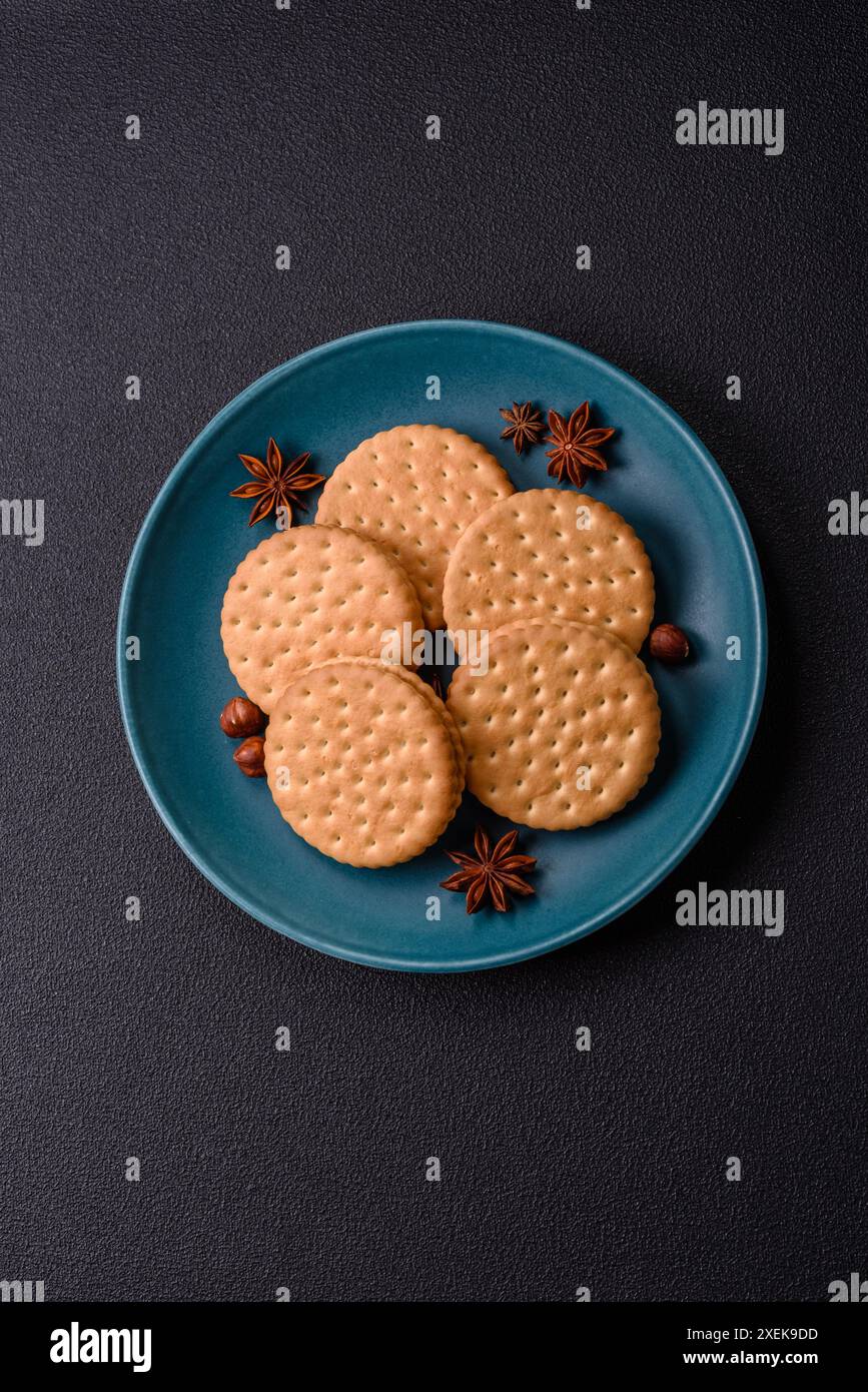 Round dotted snack snack cookies with cream on a dark concrete ...