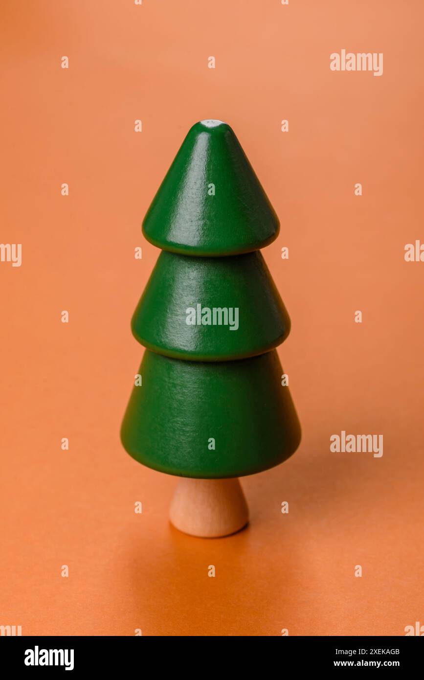 Wooden model of a tree with a green crown and trunk on a orange ...