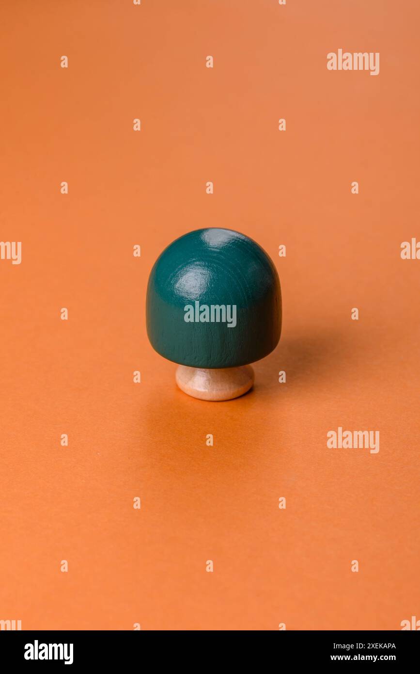 Wooden model of a tree with a green crown and trunk on a orange ...