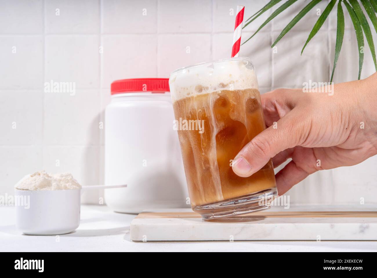 Collagen latte coffee drink glass with collagen powder in jar and spoon ...