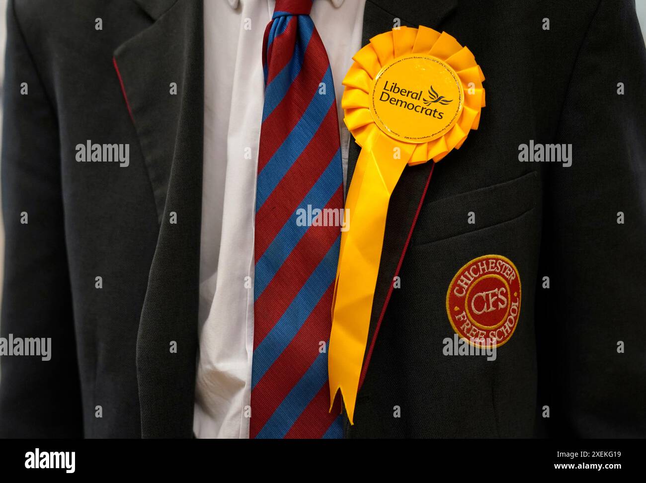 A school pupil representing the Liberal Democrats wears a rosette on ...