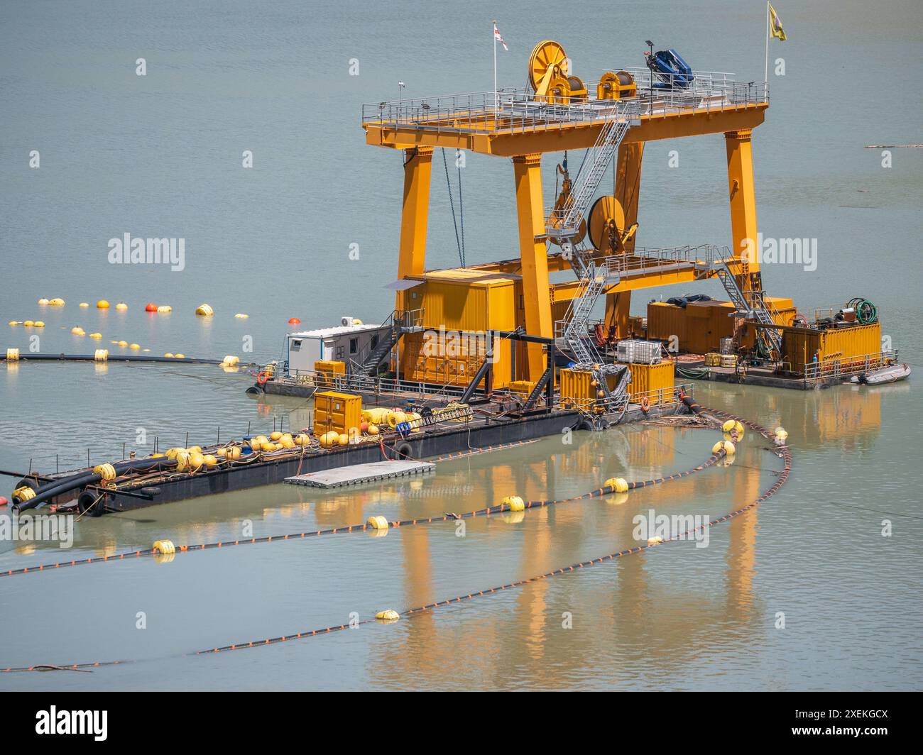yellow industrial crane on floating platform at Enguri dam, essential ...