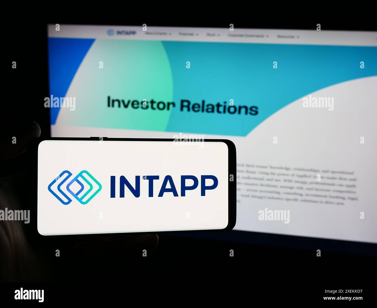 Person holding mobile phone with logo of US software company ...