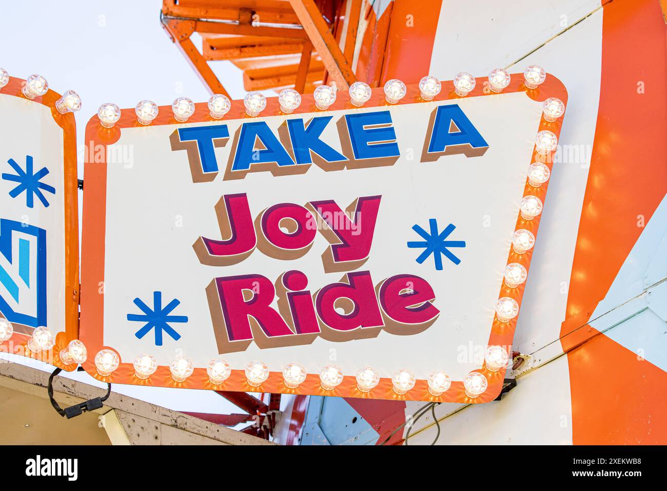 Colourful fairground ride sign saying TAKE A RIDE JOY RIDE with an ...