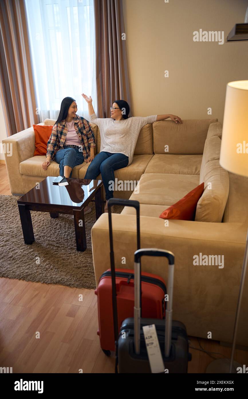 Two female tourists resting in hotel room on arrival Stock Photo - Alamy