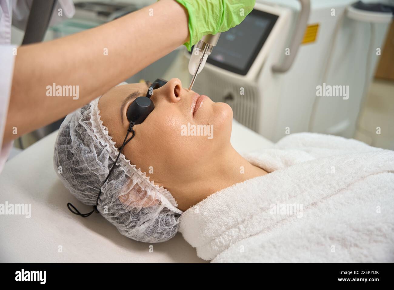 Doctor uses modern device for laser facial skin rejuvenation procedure ...