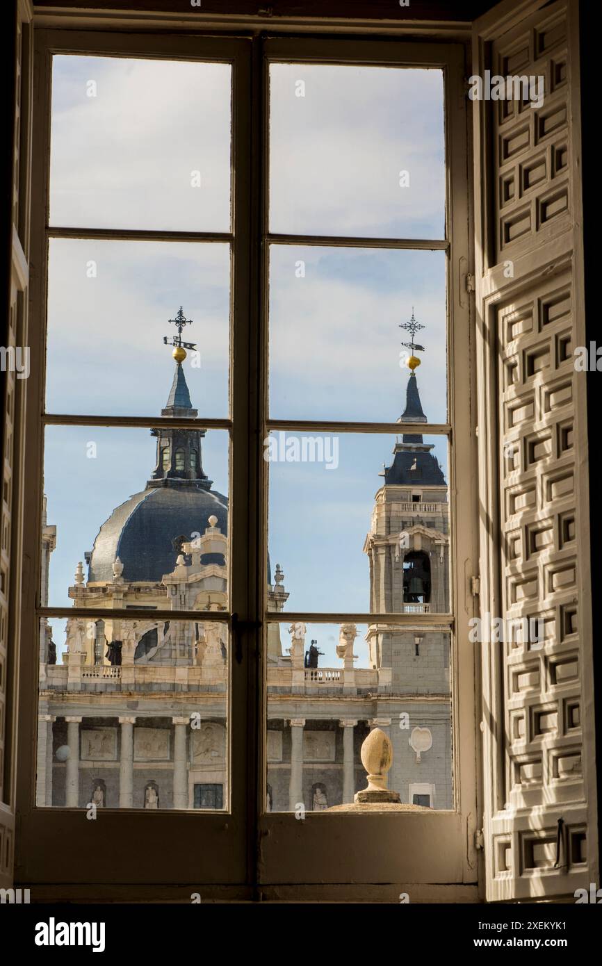 A window view of the Almudena Cathedral and courtyard of the Royal ...