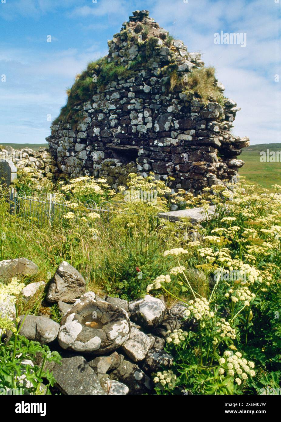 View NE showing a stone basin with coins & the eastern gable of Trumpan ...