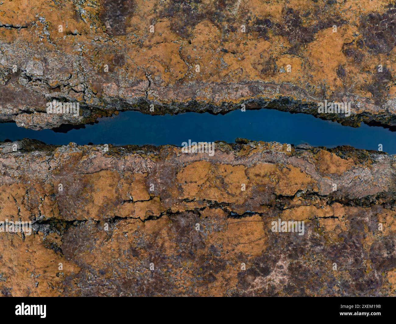 Aerial View of a Deep Earth Crack with Blue Stream in Iceland's ...