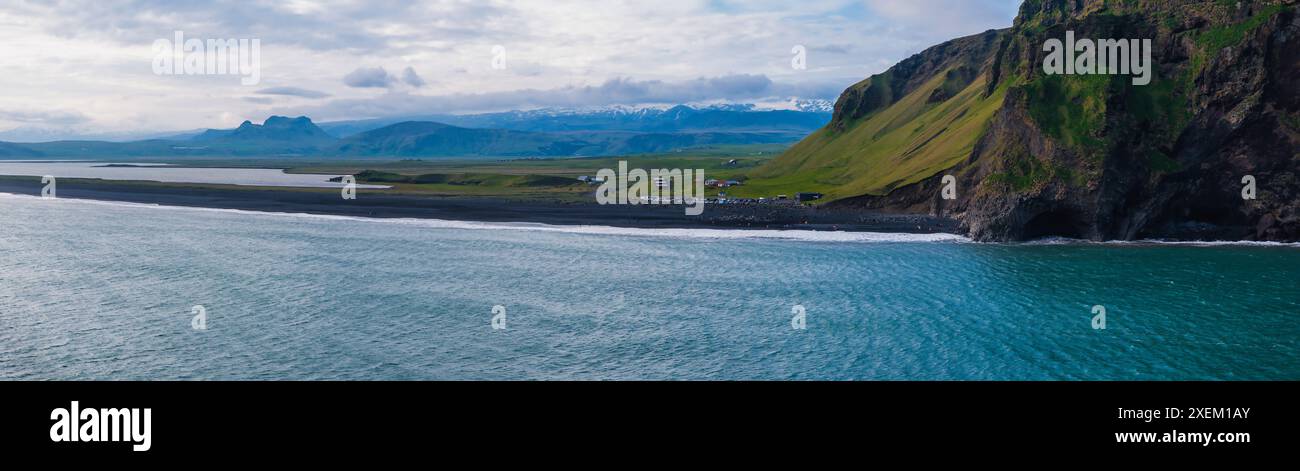 Aerial View of Black Sand Beach and Cliff Face with Turquoise Ocean in ...