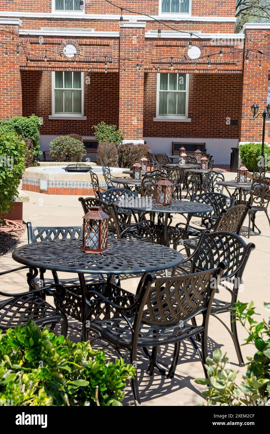Terrace with line of wrought iron tables and chairs Stock Photo - Alamy