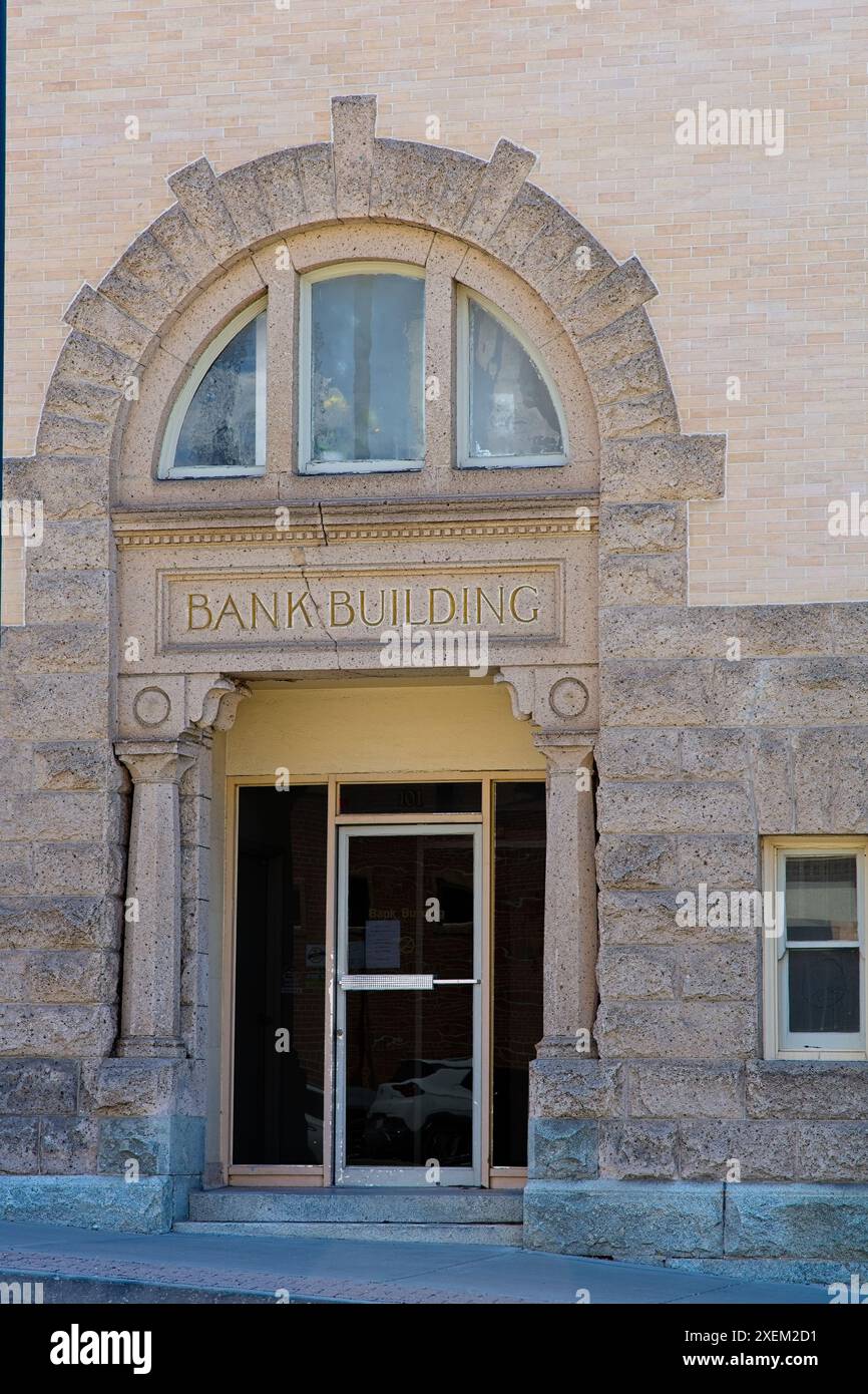 Stone arch entrance to yellow brick Bank of Arizona building built in ...