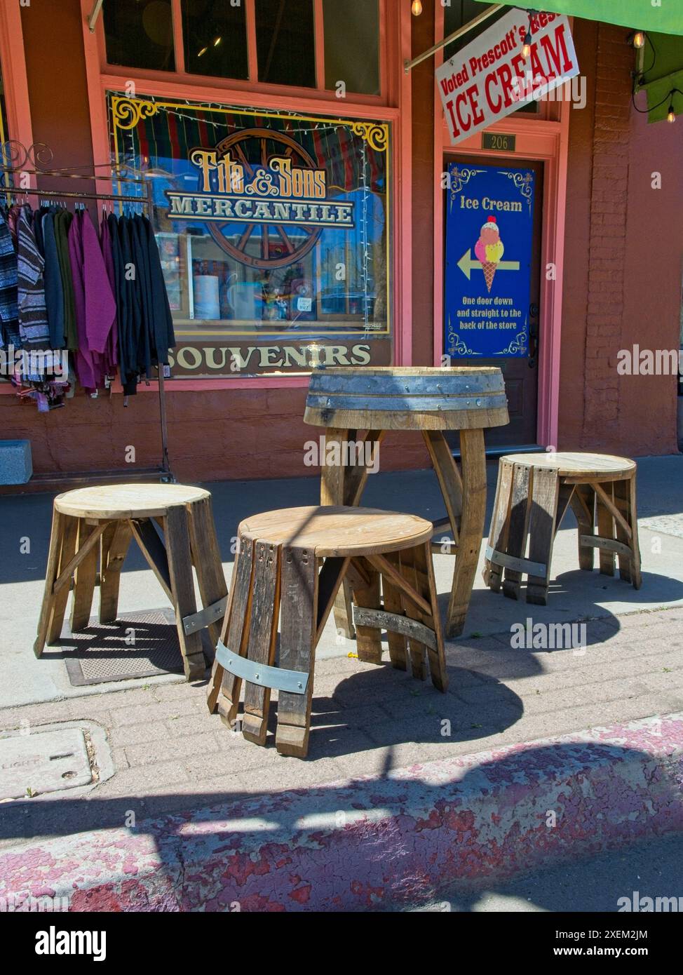 Barrel style table and stools on sidewalk outside ice cream parlor in ...