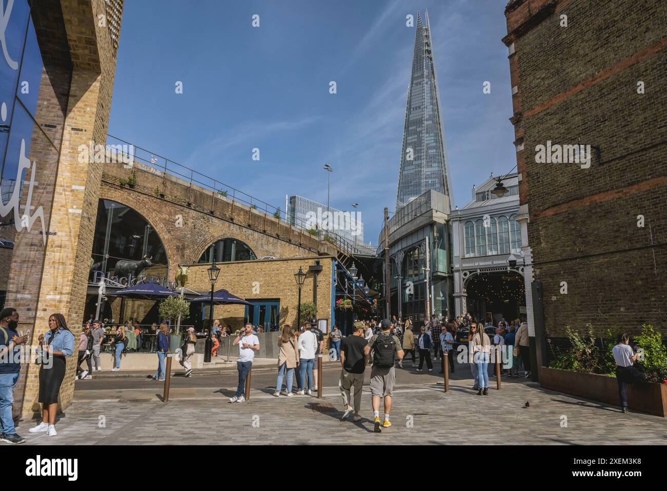 Pedestrians at Borough Market with a view of The Shard, London Bridge ...