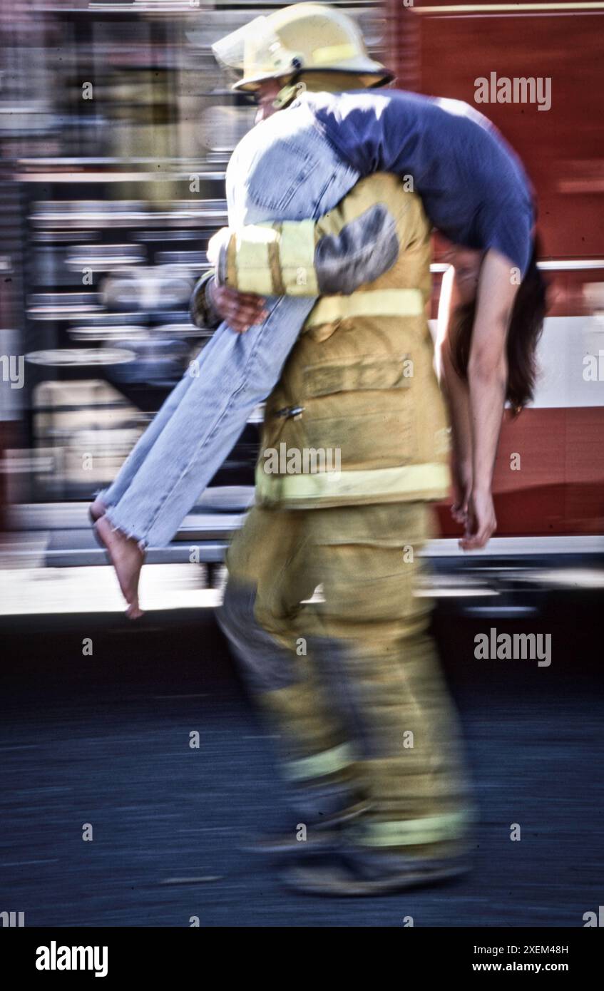 Fireman Rescuing a Young Girl at a Fire Scene, USA Stock Photo - Alamy