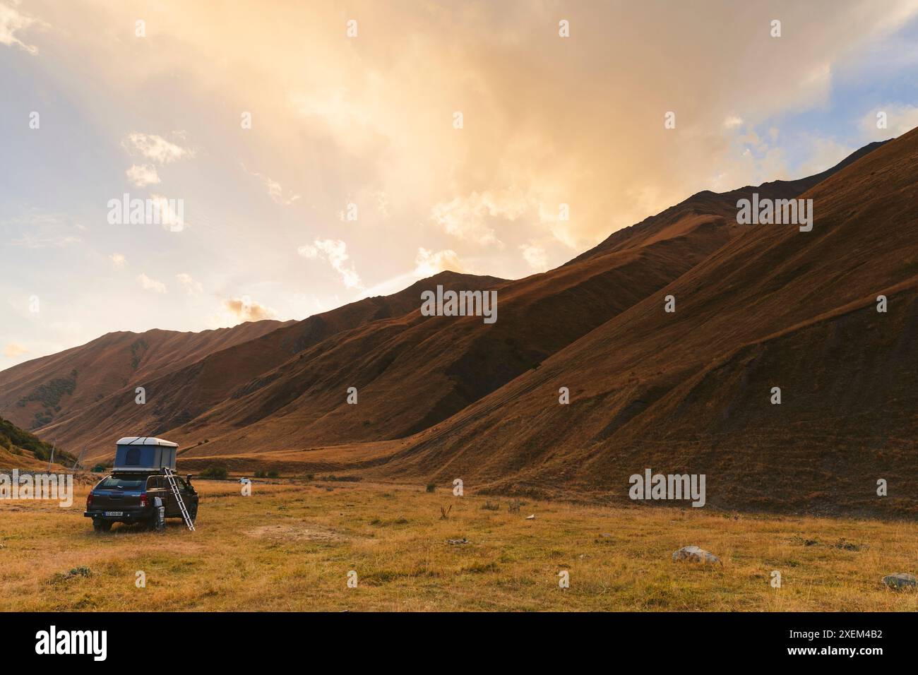 Sports utility vehicle with a tent structure on the roof parked in ...